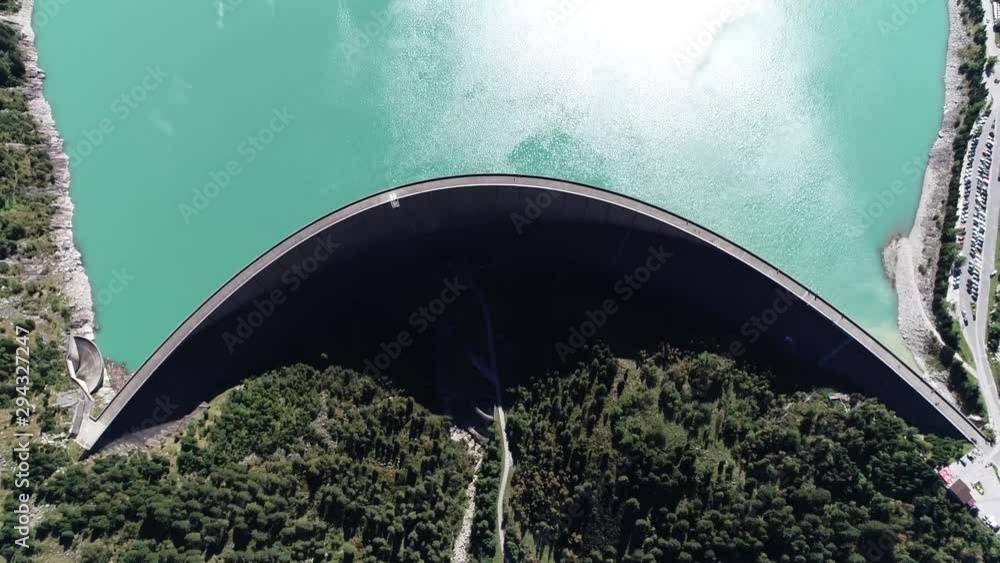 Aerial view of concrete arch gravity dam in Austrian Alps which is ...
