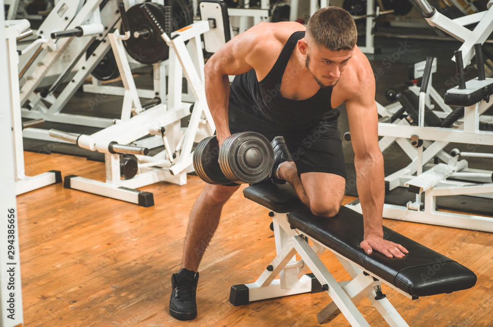 Fitness instructor in the sport room background. Male model with ...