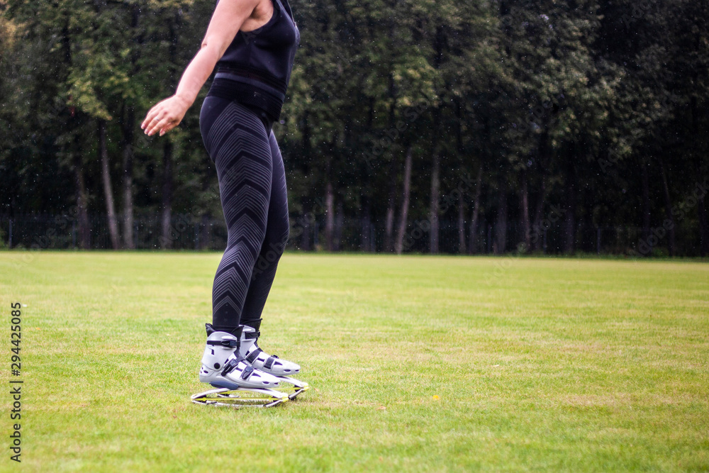 Girls in boots for jumping. Bouncing shoes on the legs of women. Sports ...