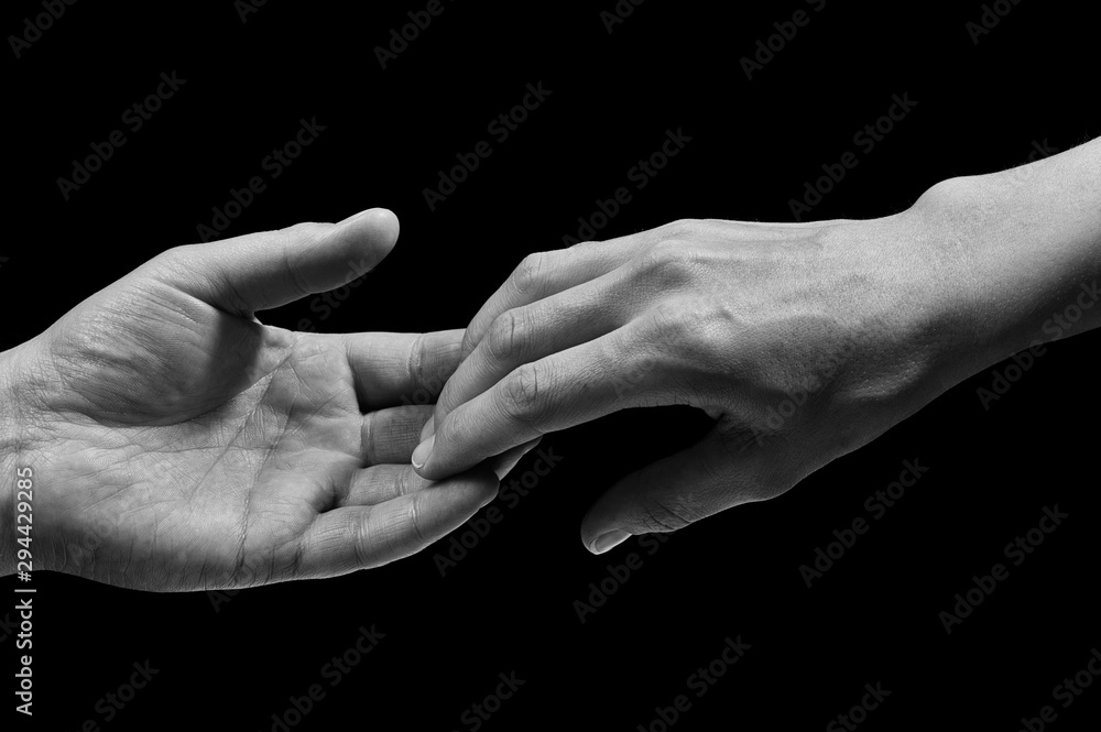 Black and white photo of two hands at the moment of breakup. The ...
