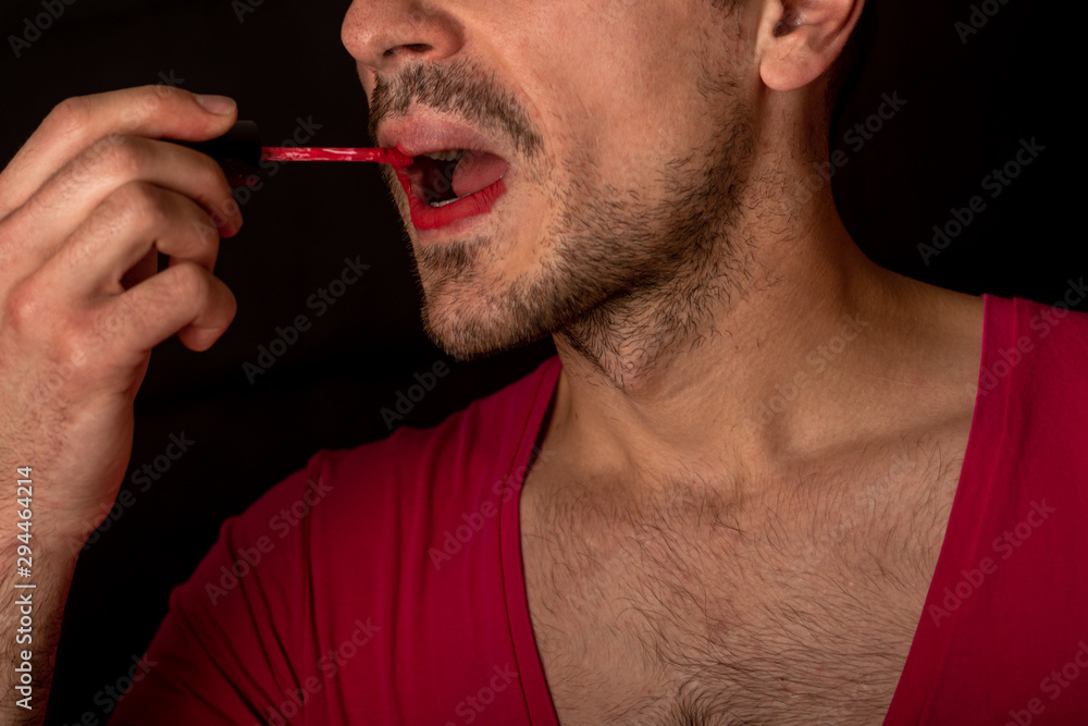 lips in lipstick on the face of a gay guy painting them with a lip ...