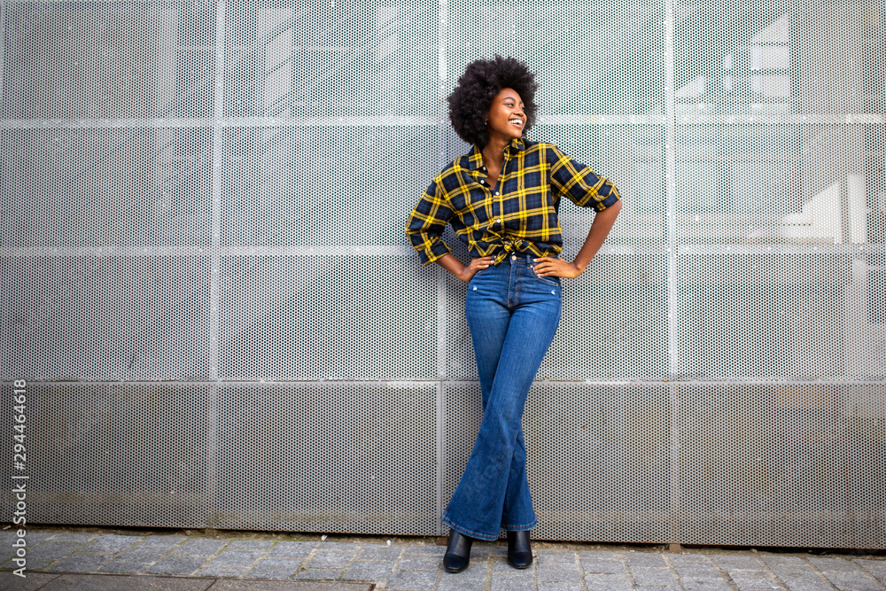 Full body fashionable young african american woman with afro smiling ...