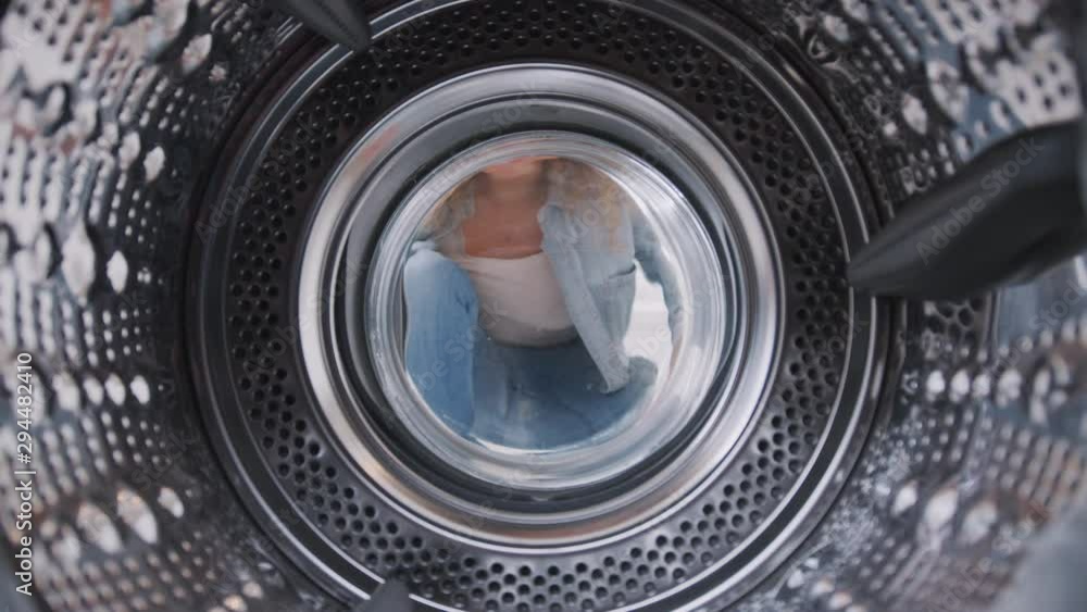 View Looking Out From Inside Washing Machine As Woman Takes Puts In ...