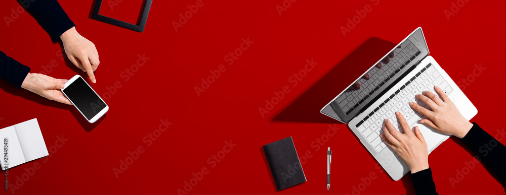 Two people working together with laptop and phone Stock Photo | Adobe Stock