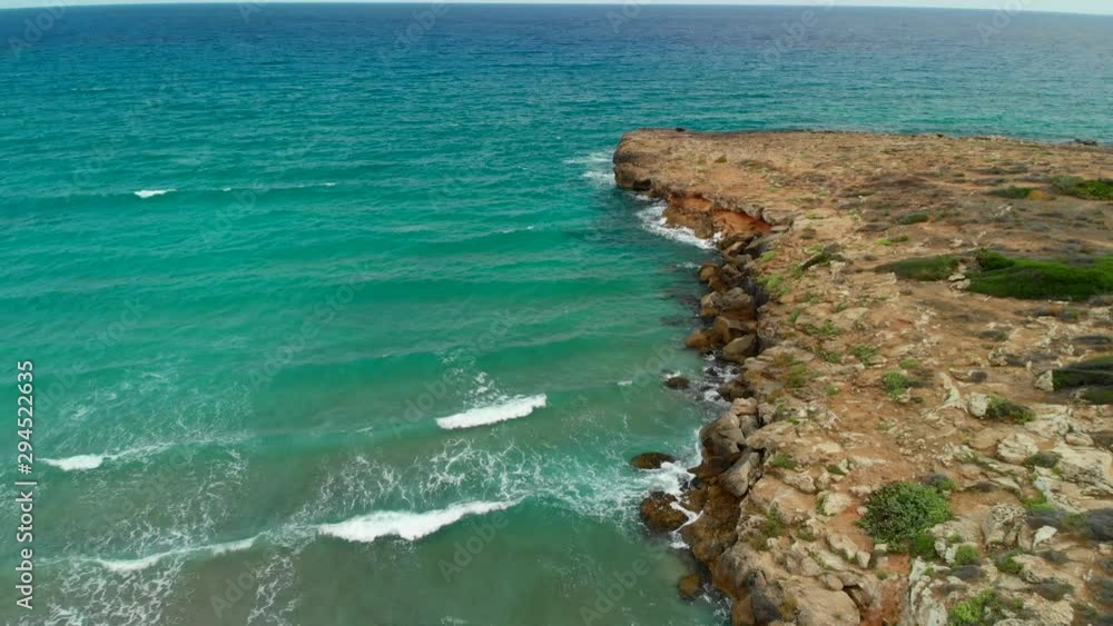 AERIAL DOLLY IN: Drone flying over Calamosche beach, in the Vendicari ...