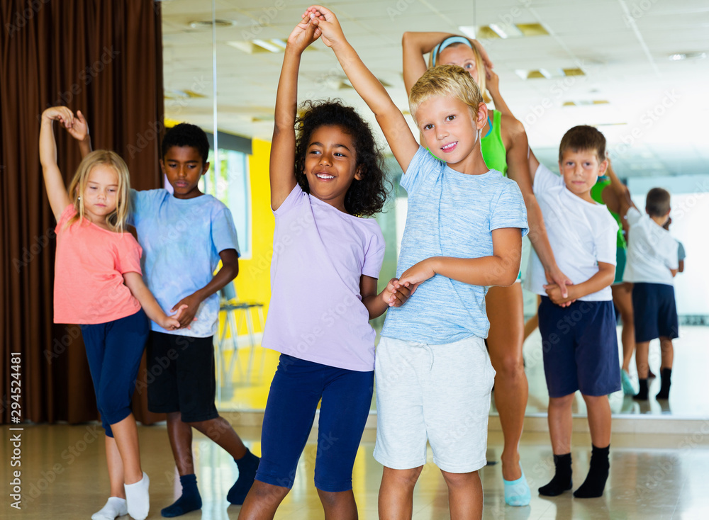 boys and girls dancing rock-and-roll in pairs with female trainer Stock ...