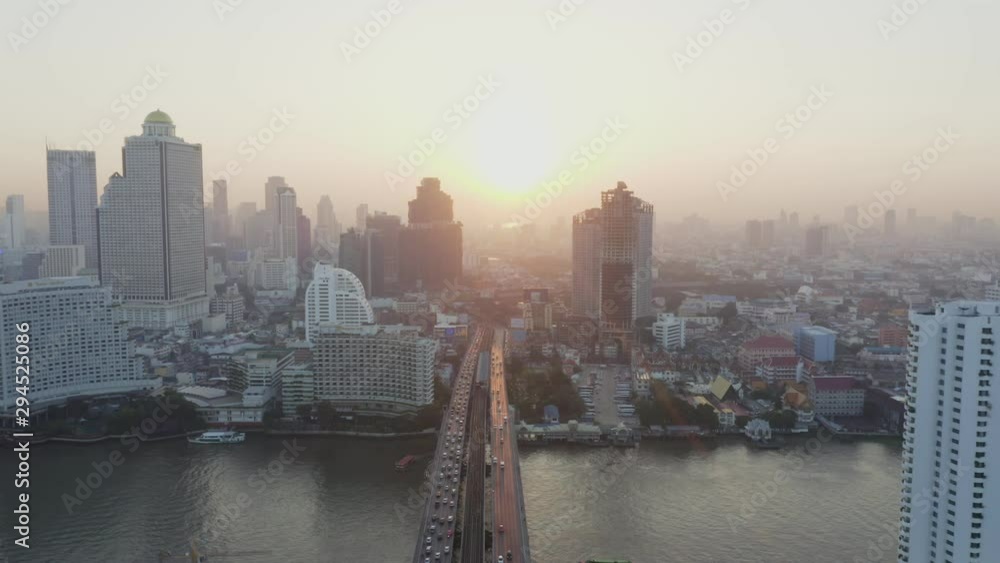 Aerial view over Bangkok city and Chao phraya river and Tak-sin bridge ...