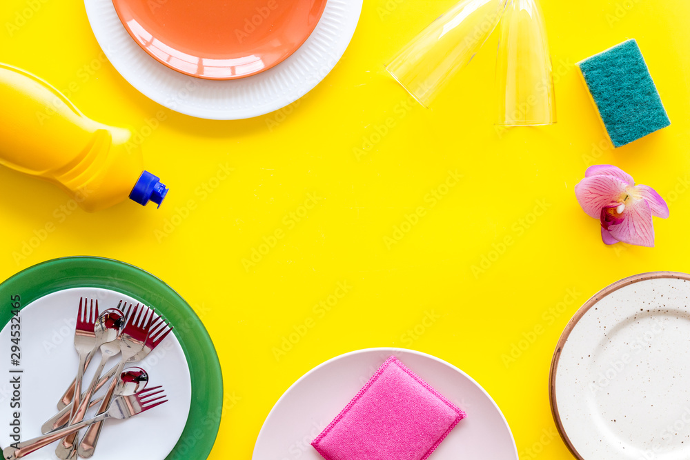 Washing dishes frame with plates, sponges, dishwashing liquid on yellow ...