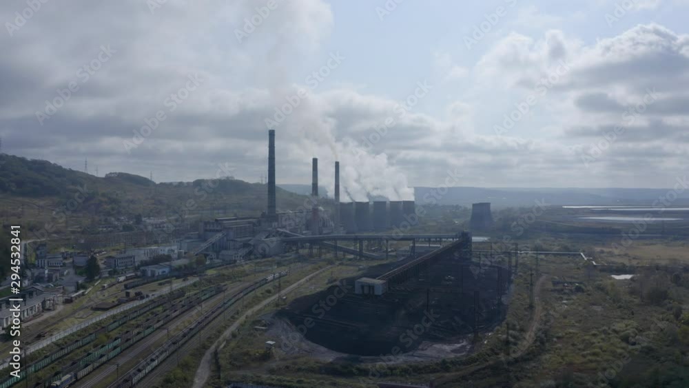 Slow push in shot of a coal-fired power station with its chimneys and ...
