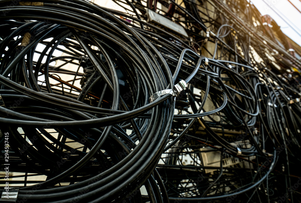 Tangled electrical wires on urban electric pole. Disorganized and messy ...
