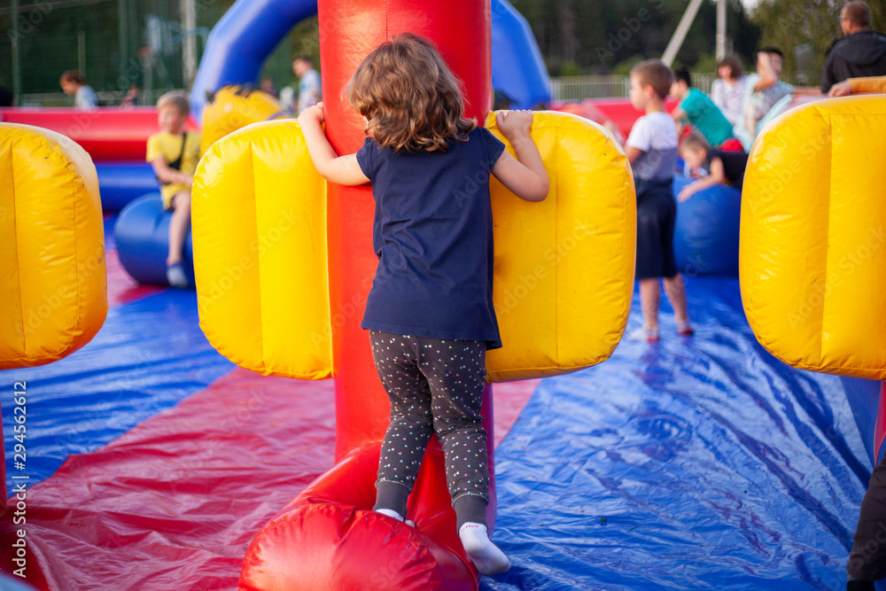 Foto de A child in an amusement park. Inflatable playground. Children ...