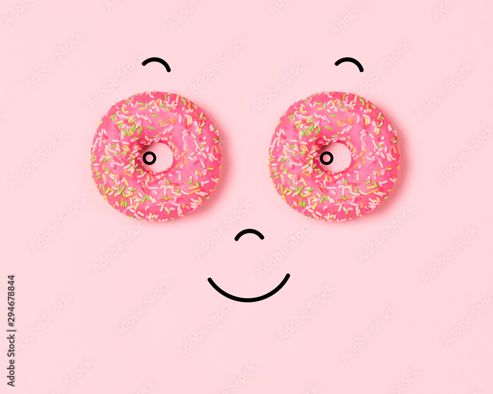 Funny smiling donuts face on pastel pink background. Happy sweet face ...