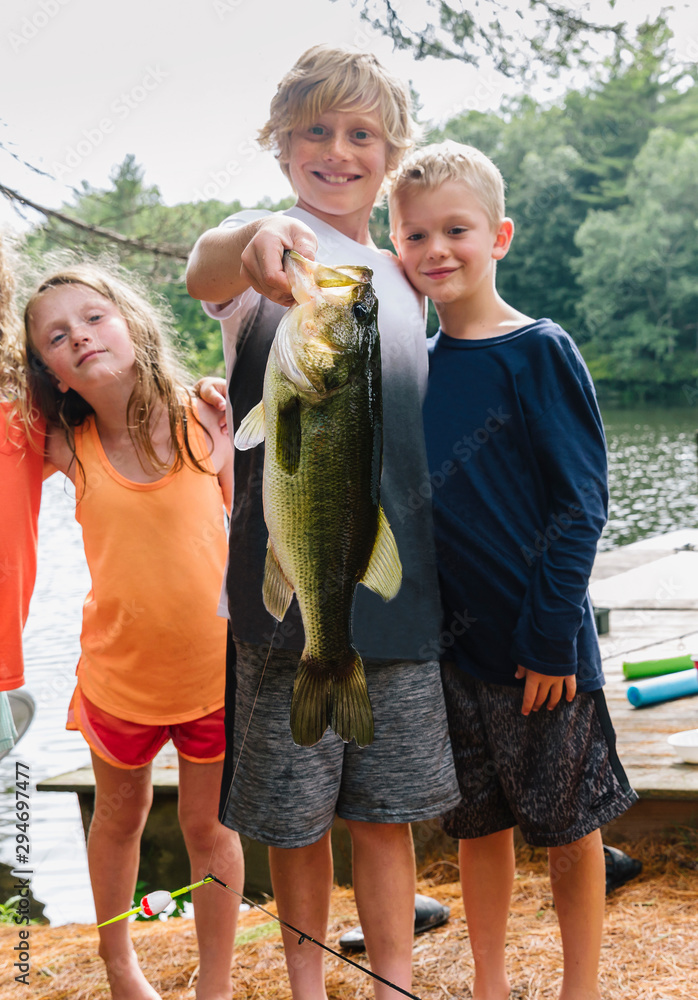 Proud Family of Kids Holding Large Fish Stock Photo | Adobe Stock