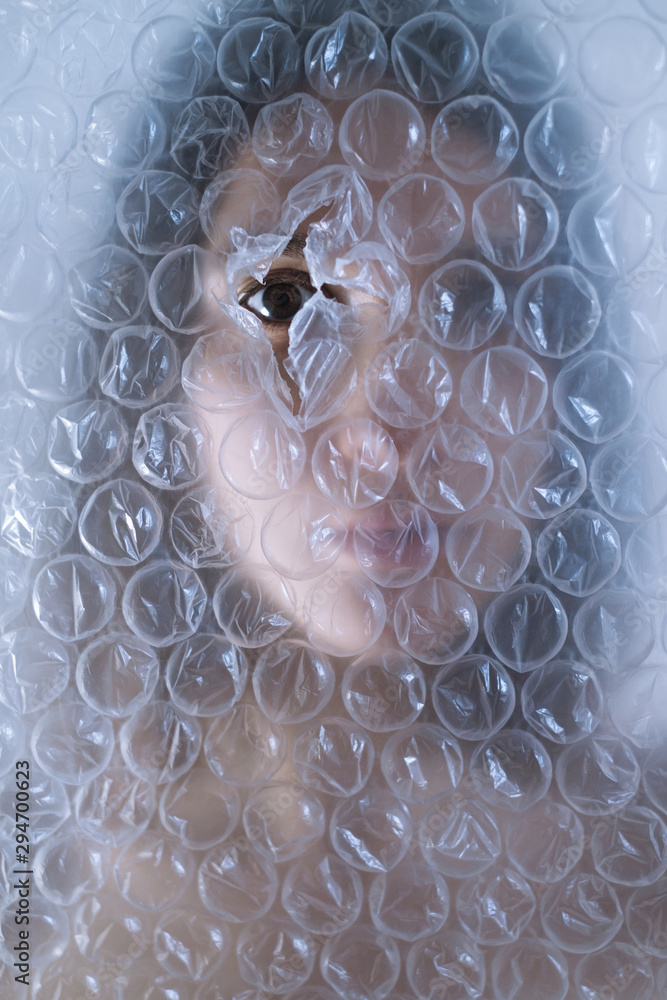 Woman face trough bubble wrap Stock Photo | Adobe Stock