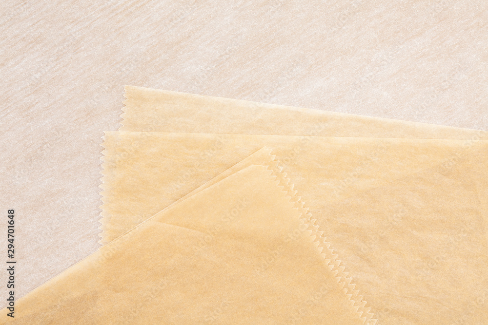 Layers of parchment paper background in two tones light tan and beige ...
