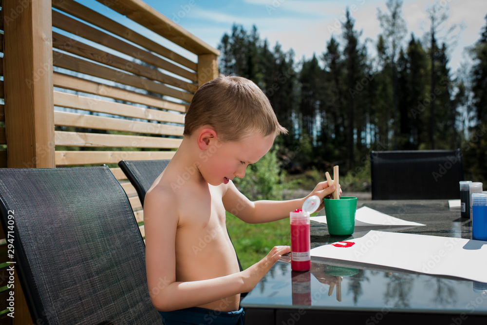 Young boy painting outside in the sunshine Stock Photo | Adobe Stock