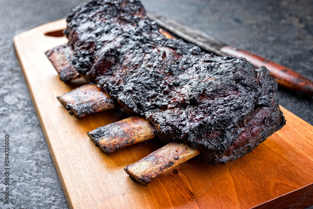 Barbecue burnt chuck beef ribs with hot rub as closeup on a modern ...
