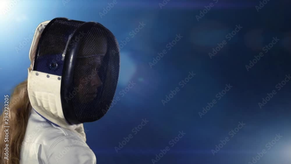 Fencer puts on mask and becomes fencing combat stance. Sport girl ...