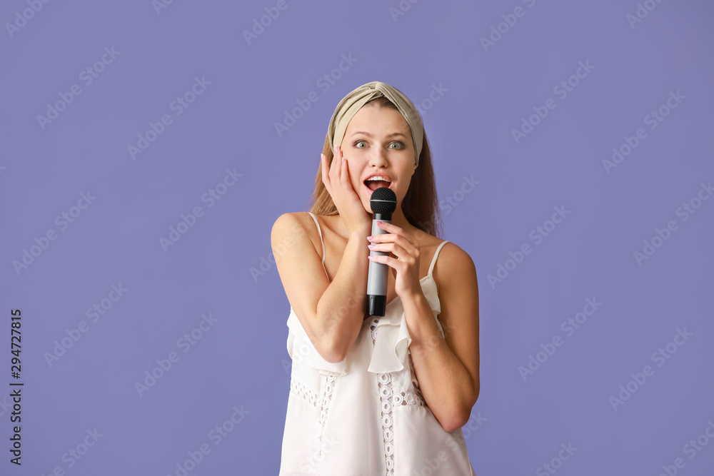Beautiful young female singer with microphone on color background Stock ...