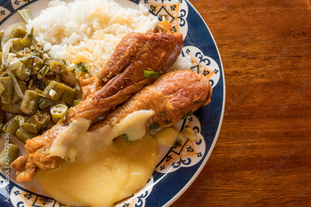 Traditional brazilian food, chicken, and okra a table background ...