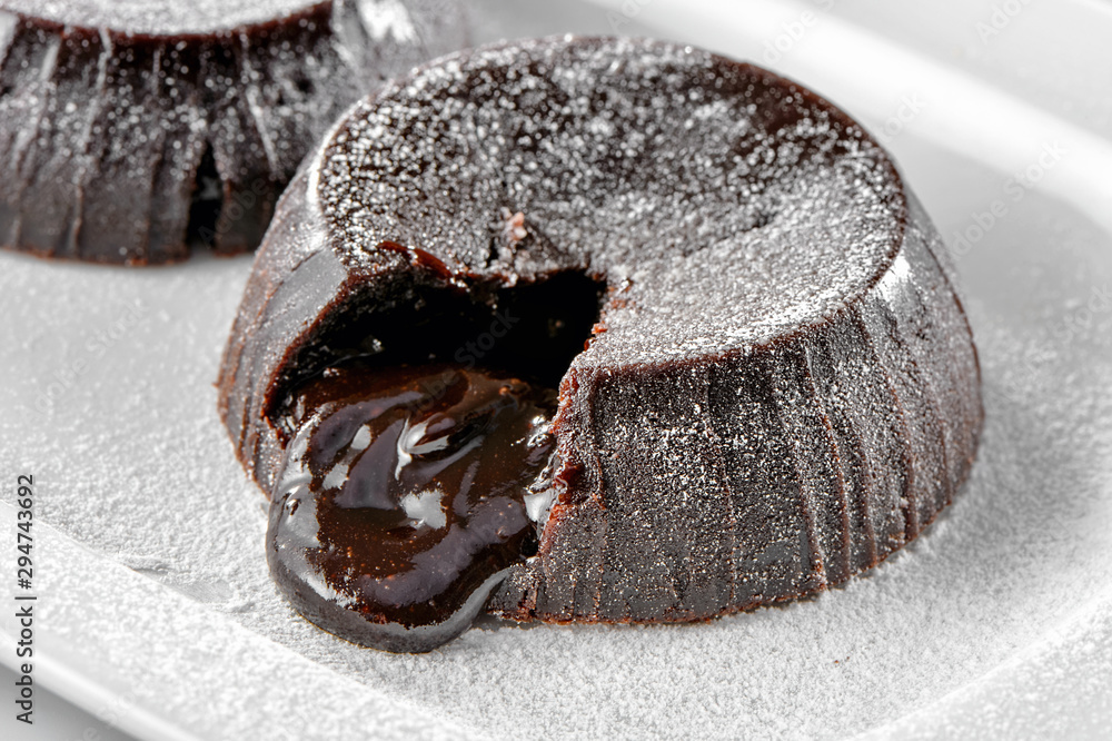 chocolate lava brownie cakes with powdered sugar close-up on white ...