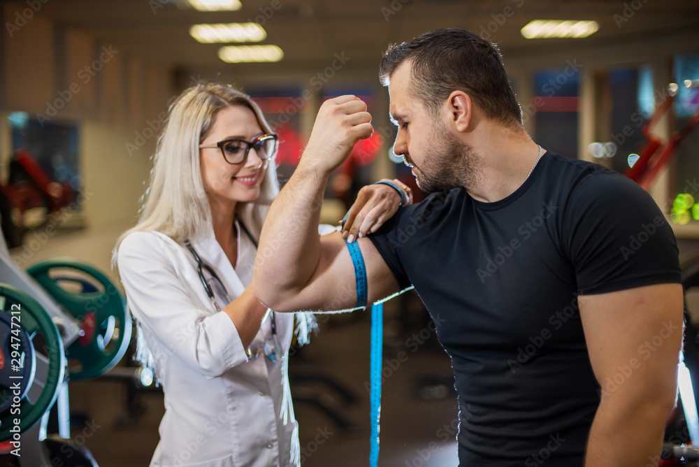 Medical examination. An attractive doctor measures the volume of an ...