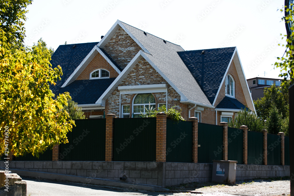 Beautiful country house behind a high fence. Chic cottage in a holiday ...