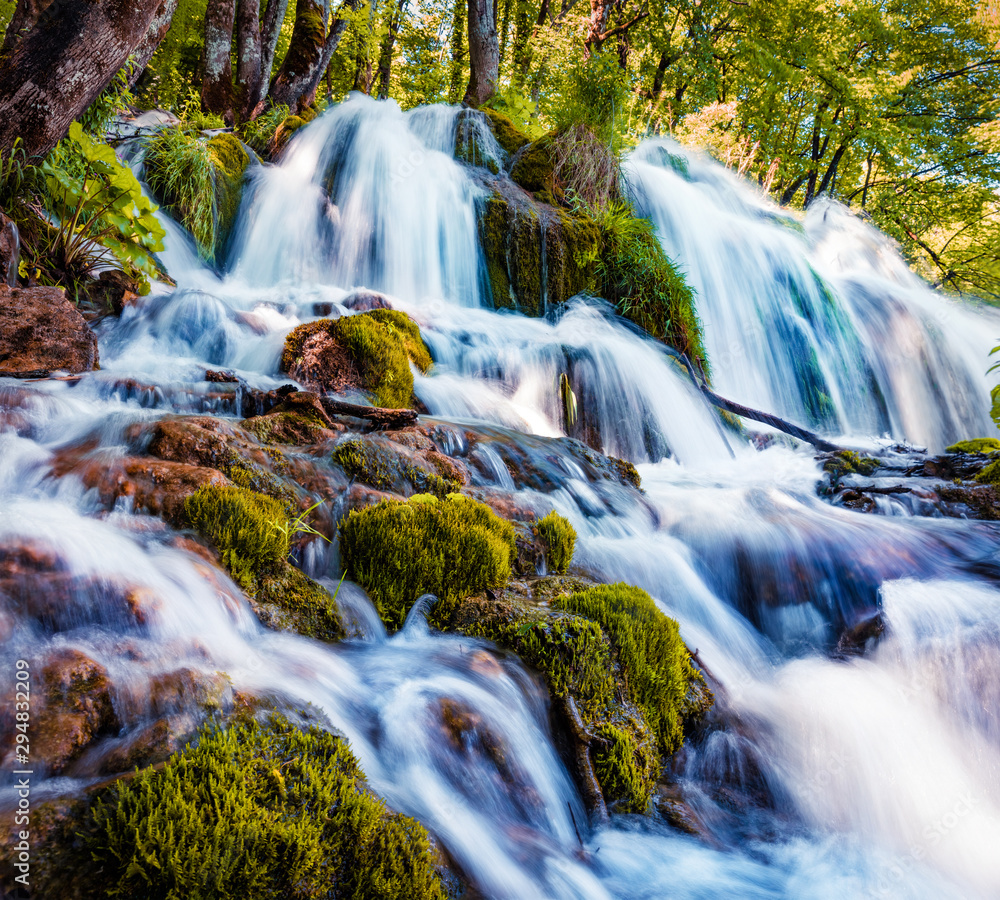 First sunlight lights up the pure water waterfall on Plitvice National ...