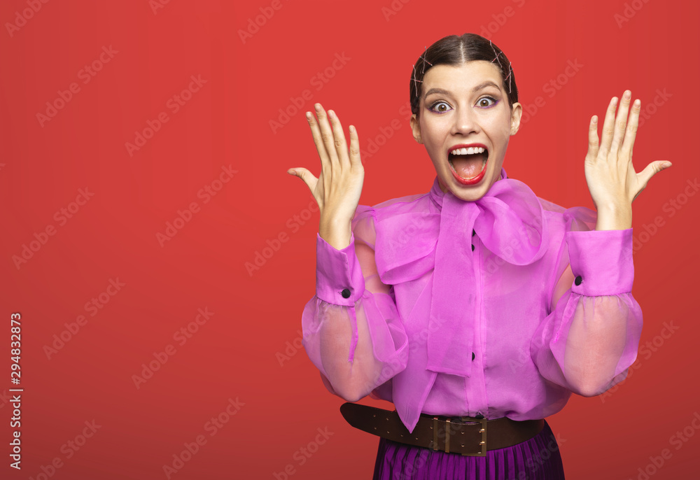 girl actress posing with positive emotion. in the Studio on a red ...