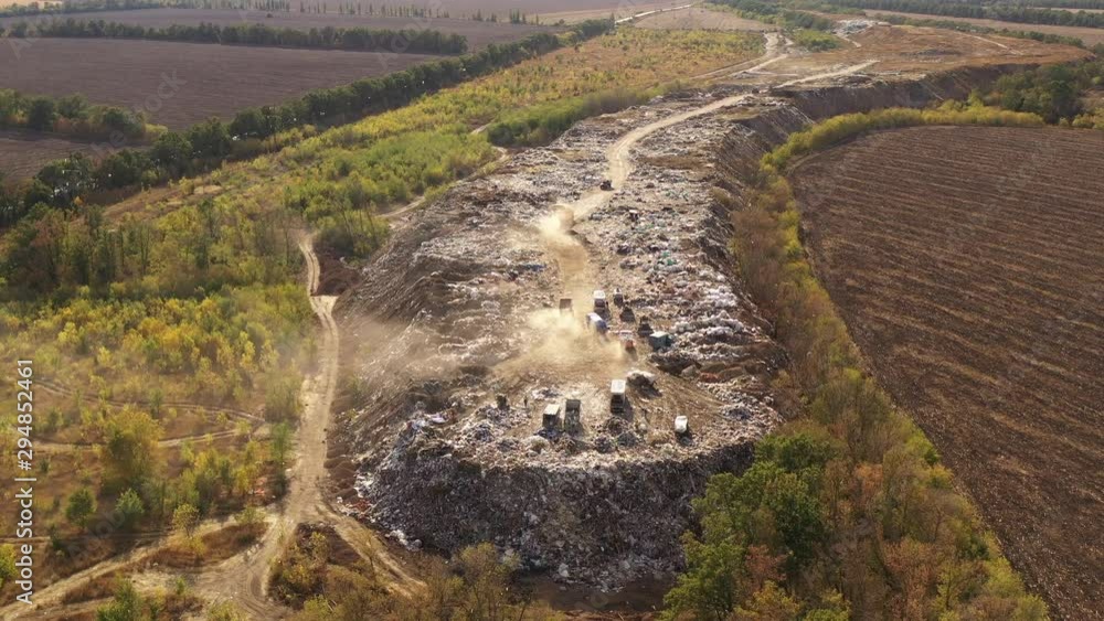 Aerial view of large garbage pile at sorting site. Trucks bring waste ...
