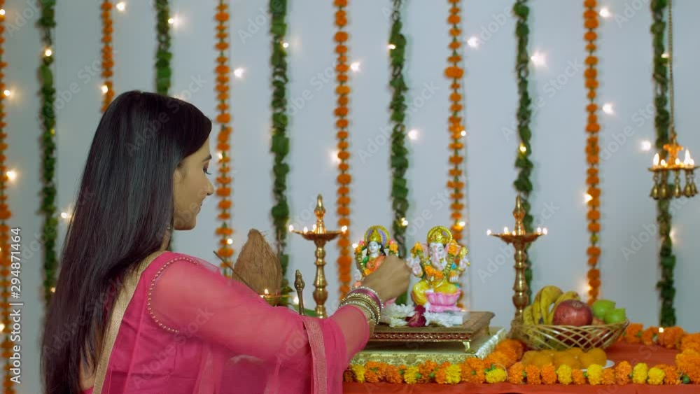 Pretty Indian lady performing Hindu traditions of worshipping Lakshmi ...