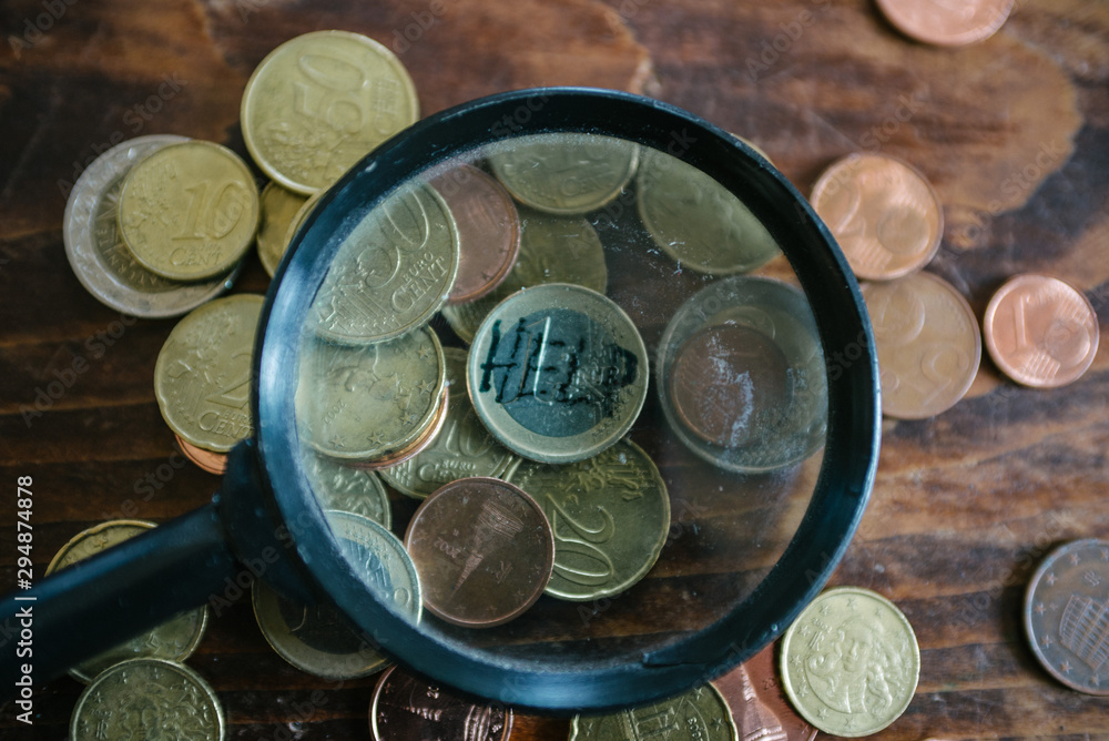 magnifying glass over a euro coin Stock Photo | Adobe Stock