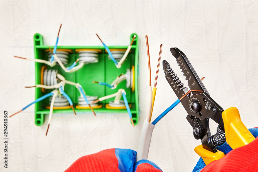 Using a stripper cutter tool for electrical work. Stock Photo | Adobe Stock