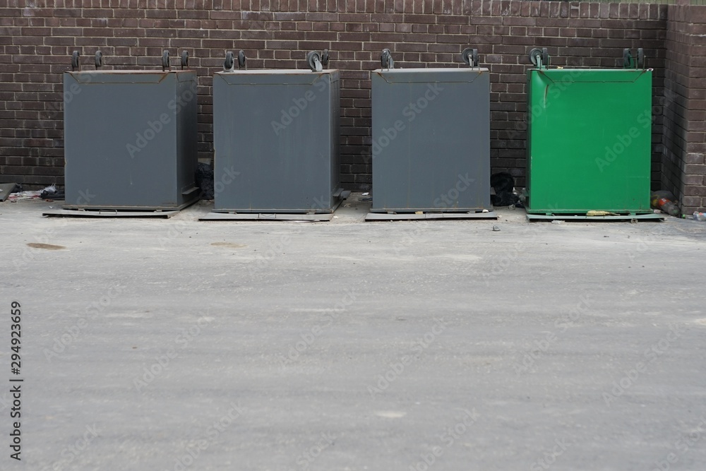 inverted insulated garbage containers of gray and green color on the ...