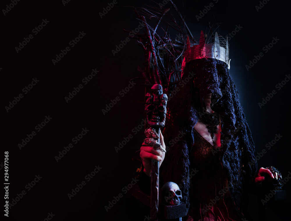 Female witch queen sitting on throne made of branches. Stock Photo ...