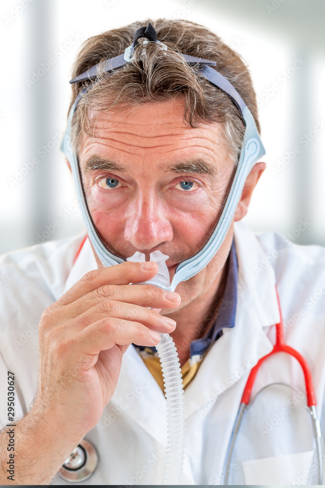 Doctor demonstrating Treatment of sleep apnea and snoring for patient ...