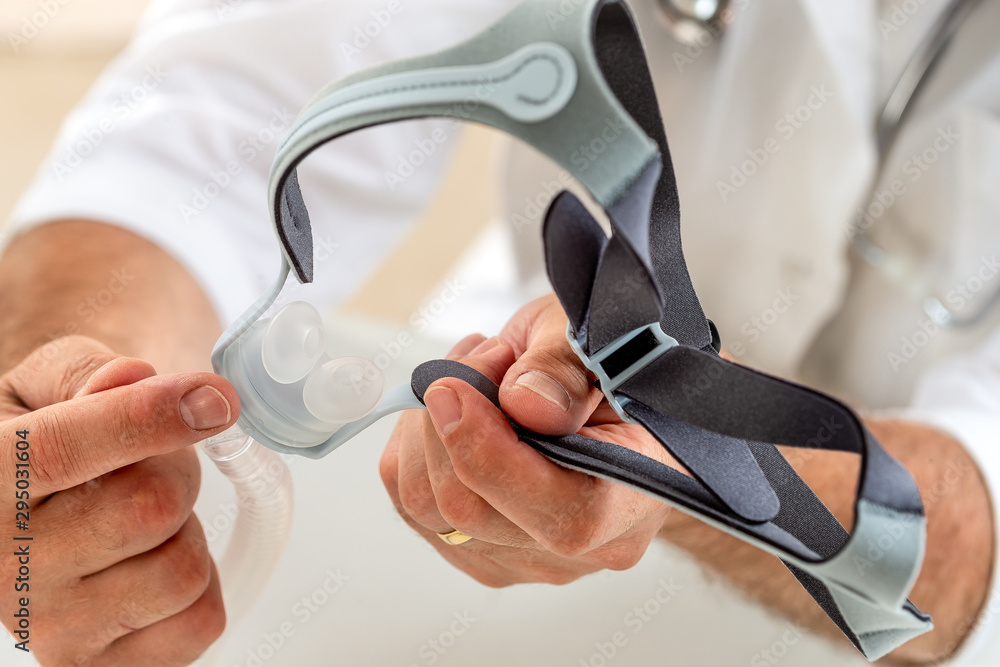 Doctor Demonstrating Treatment Of Sleep Apnea And Snoring For Patient