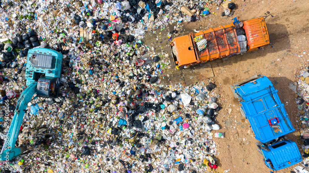 Garbage trucks unload garbage to open landfill, Surface and subsurface ...