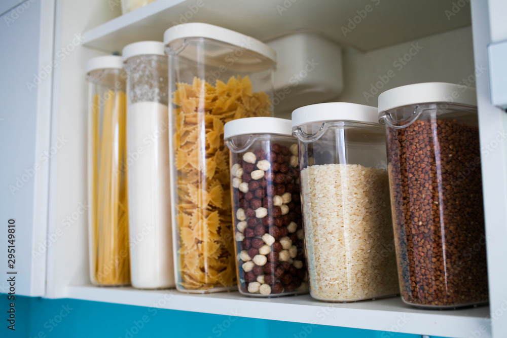 Stocked kitchen pantry with food - pasta, buckwheat, rice and sugar ...