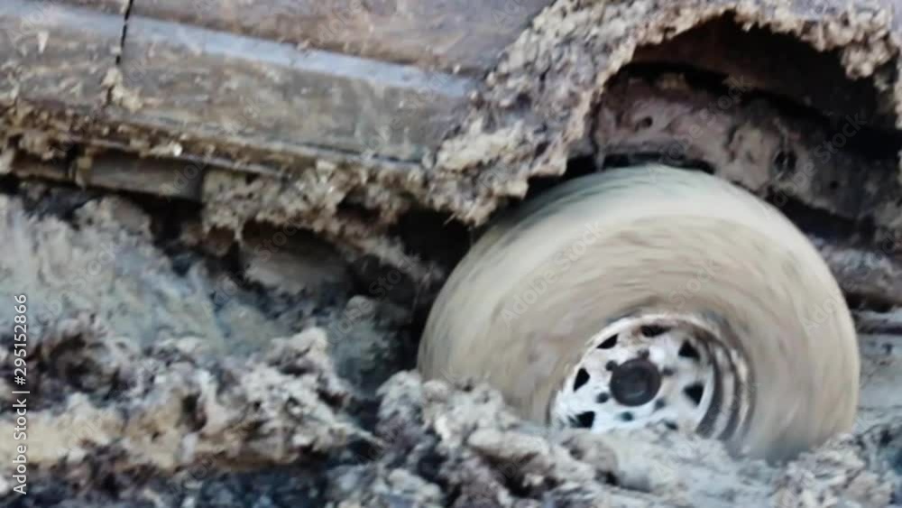 Offroad car in the swamp. The car is stuck in a puddle. The wheels are ...