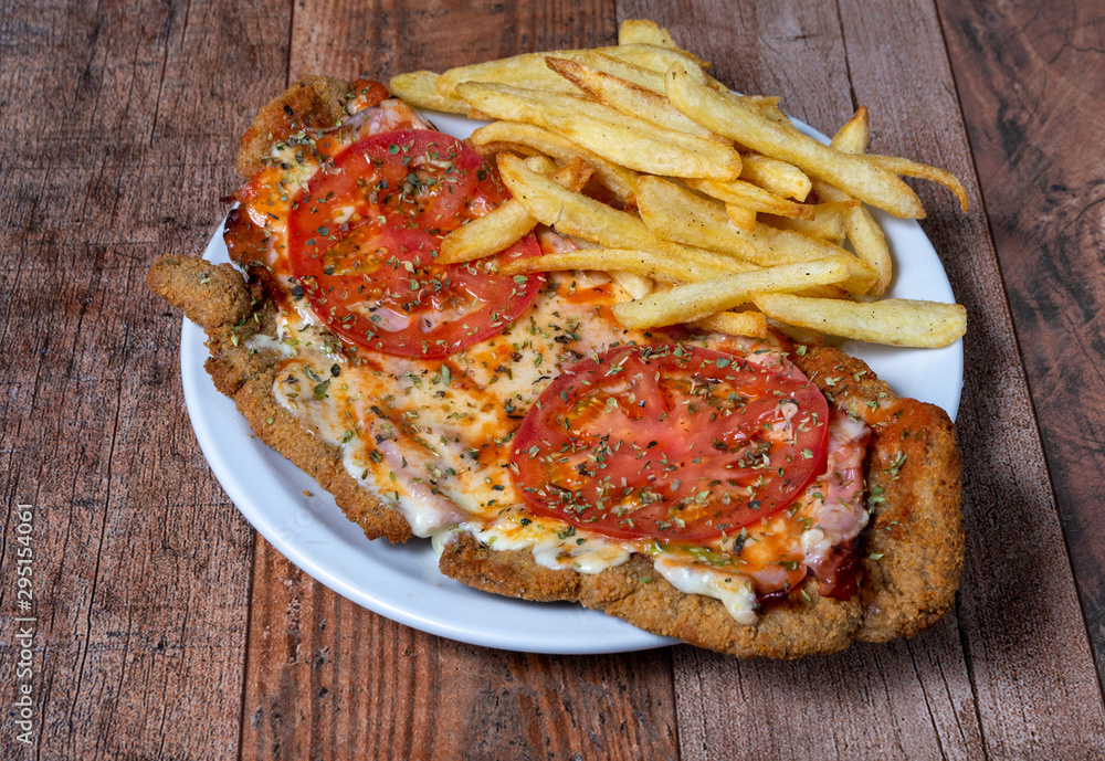 milanesa napolitana con papas fritas Stock Photo | Adobe Stock