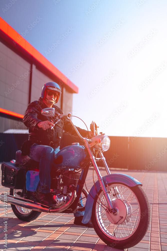 Soft light. Portrait of a middle-aged man, an old biker in a leather ...