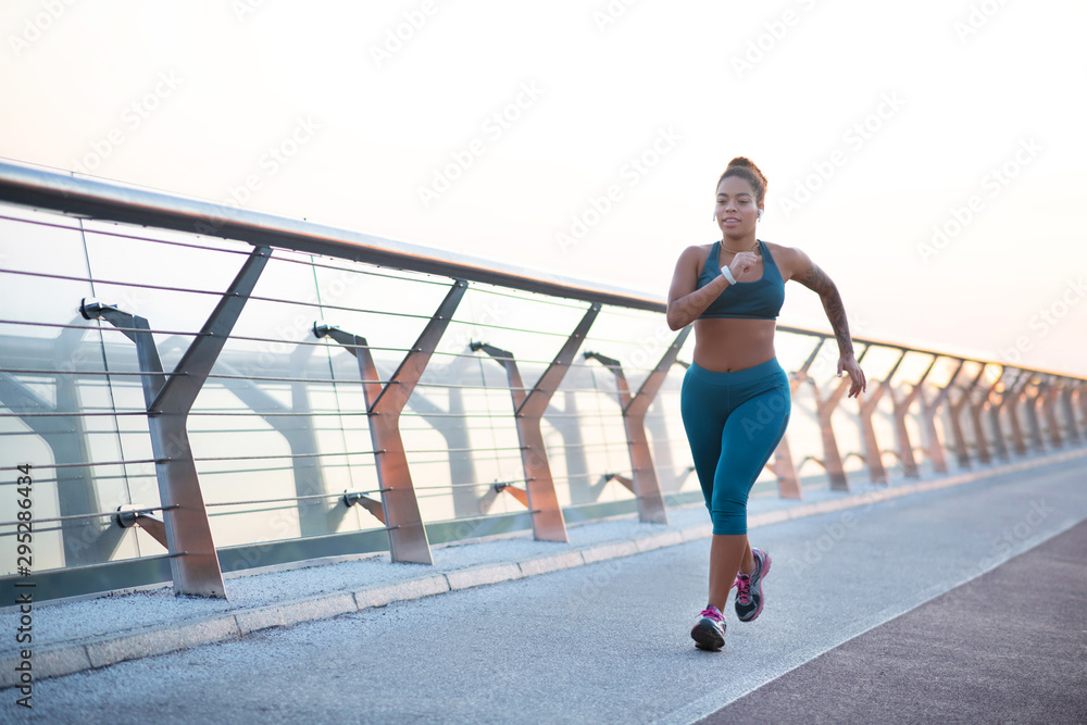 Dark-skinned young overweight woman running really fast Stock Photo ...