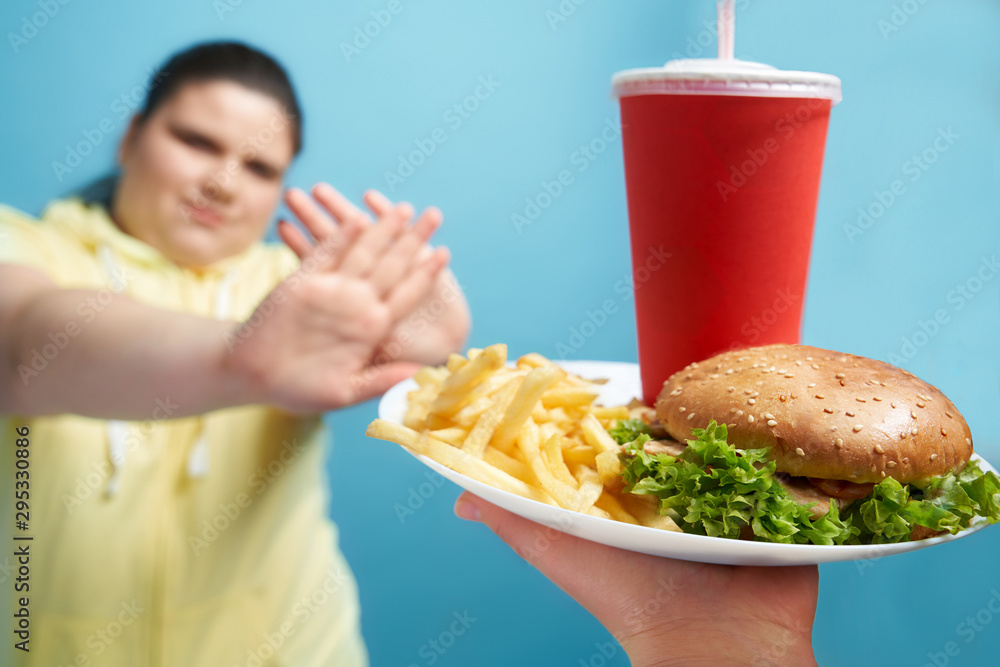 Overweight female denying fast food in her healthy lifestyle Stock ...