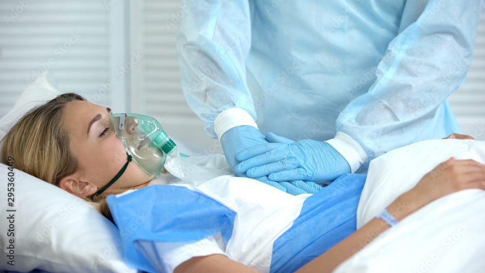 Doctor making cardiopulmonary resuscitation to female patient ...