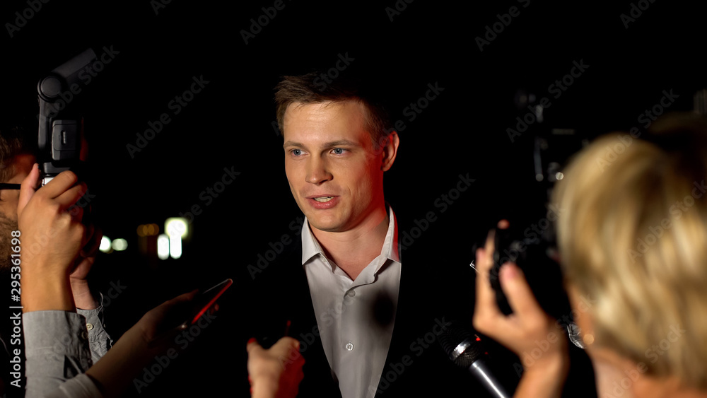 Handsome actor giving interview on press conference before movie ...