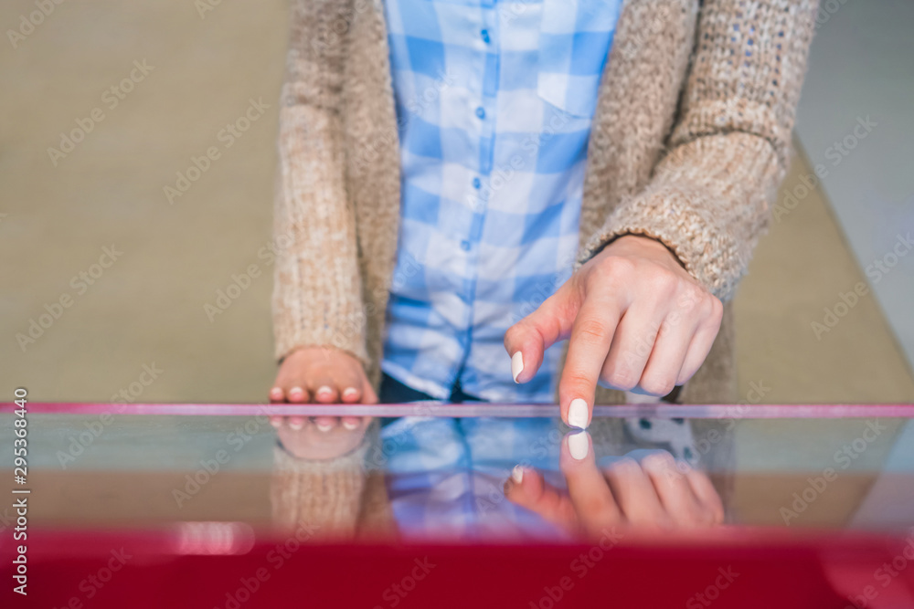 Woman hand using interactive touchscreen display of electronic ...
