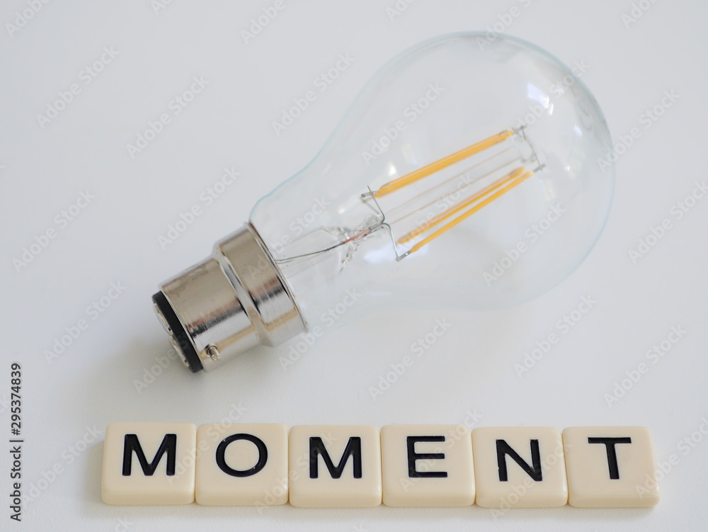 Modern bayonet LED lightbulb with word moment underneath in black ...