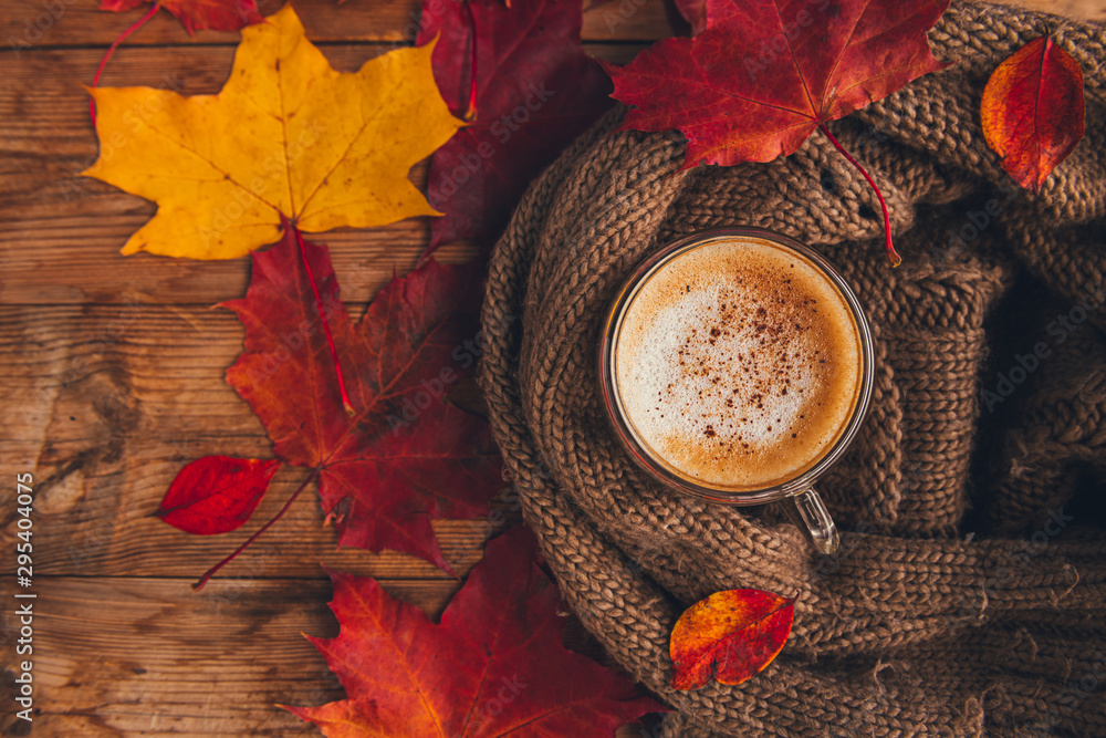 Autumn, fall leaves, hot cup of coffee and a warm wool scarf on wooden ...