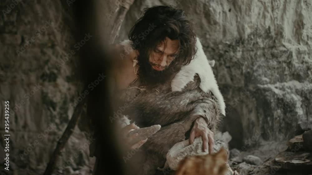 Primeval Caveman Wearing Animal Skin Holds Sharp Stone and Makes First ...